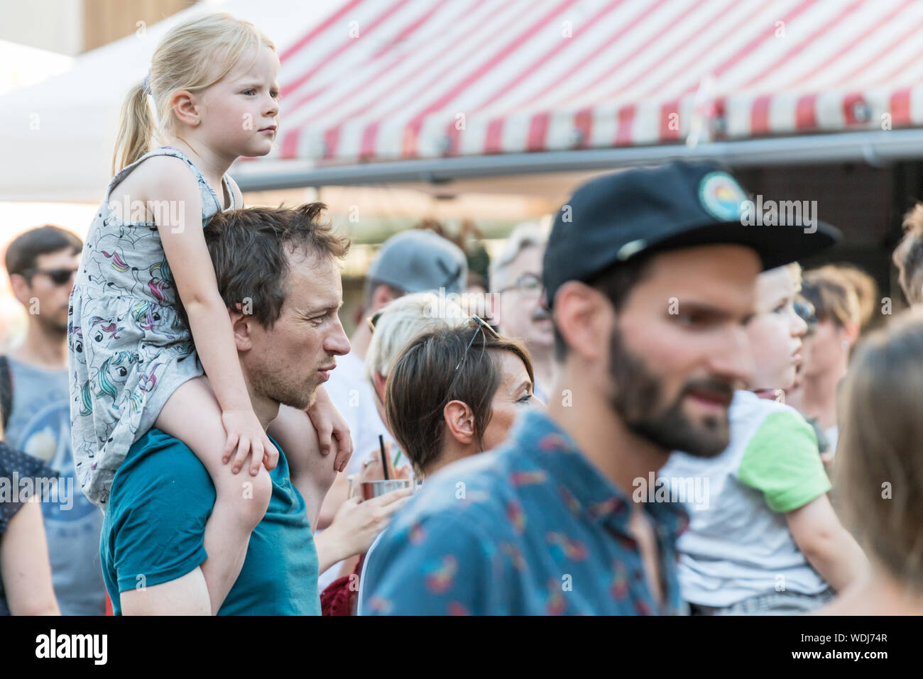 Regensburg, Bavaria, Germany, June 28, 2019, Little girl sitting on her ...