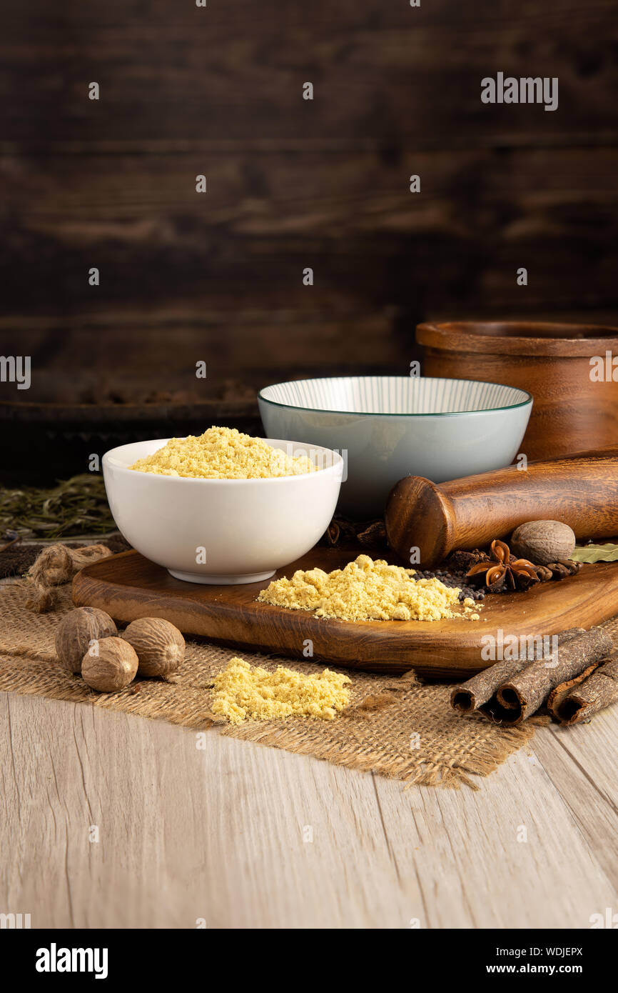 YELLOW MUSTARD POWDER in a bowl and food preparation and kitchen set ...