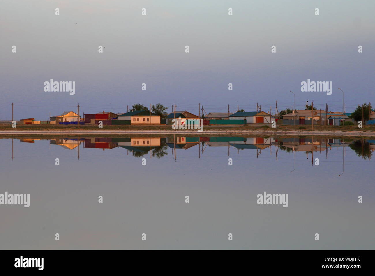 Aralsk village and their reflection on the water Stock Photo - Alamy