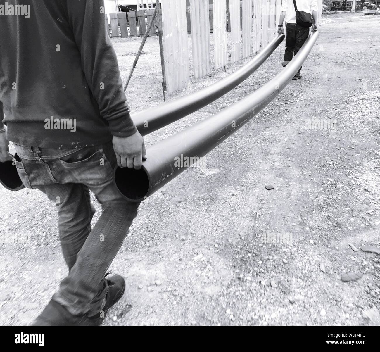 Construction worker carrying pipes hi-res stock photography and images ...