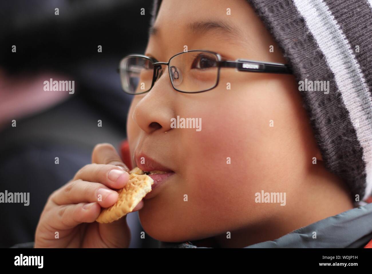 Indian boy eating biscuit hi-res stock photography and images - Alamy