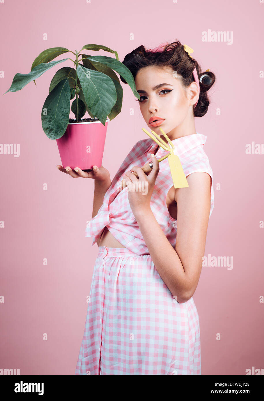 greenhouse worker or gardener. pin up woman with trendy makeup. pretty ...
