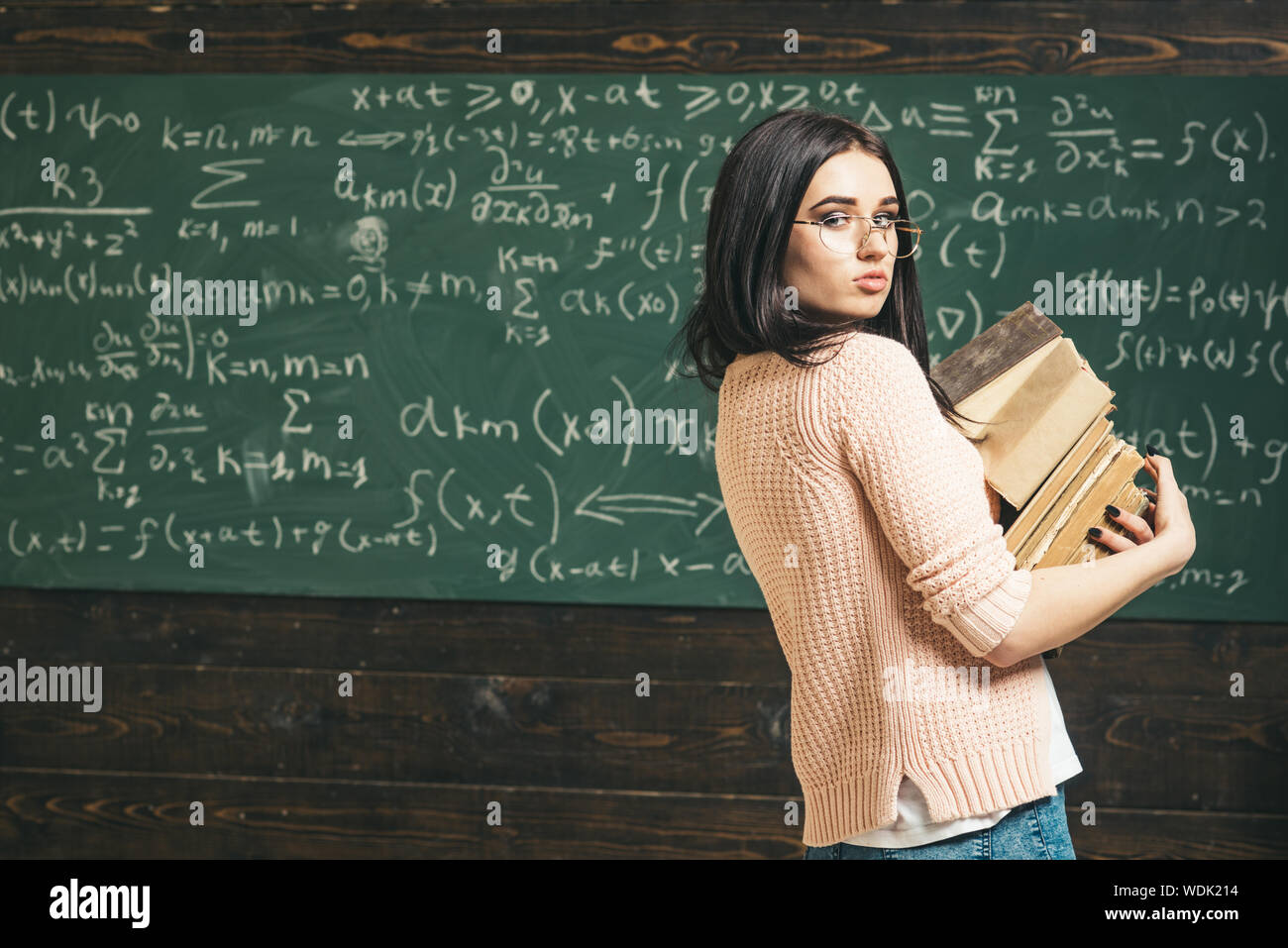 Course Project Girl Holds Heavy Pile Of Old Books Chalkboard