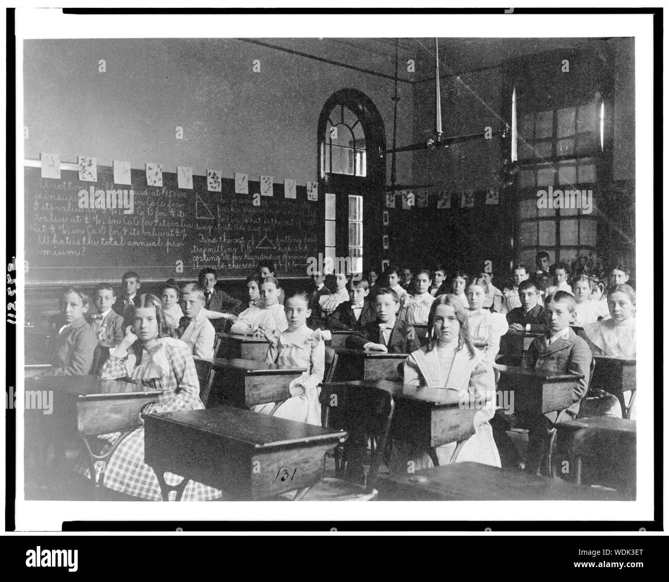 Boys girls seated in Black and White Stock Photos & Images - Alamy