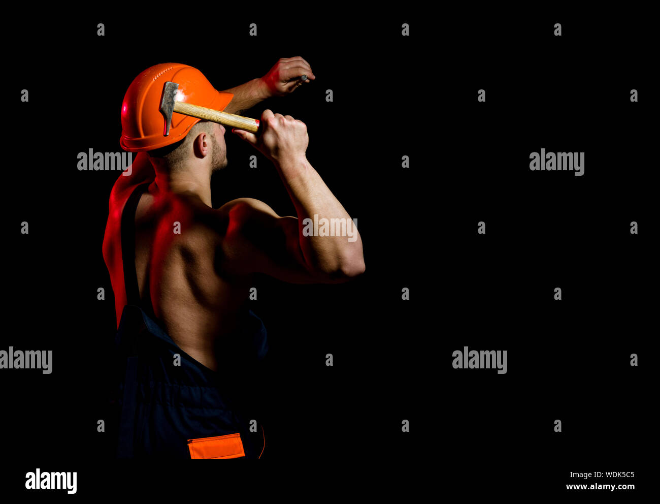 Building under construction. Muscular man builder at work under ...