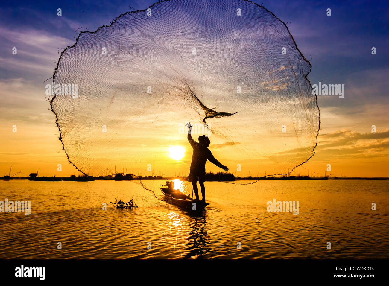 Silhouette fisherman throwing net in hi-res stock photography and ...