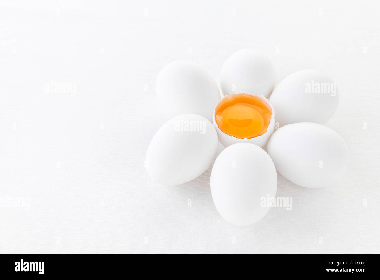 fresh white eggs with yolk on white background, closeup Stock Photo - Alamy