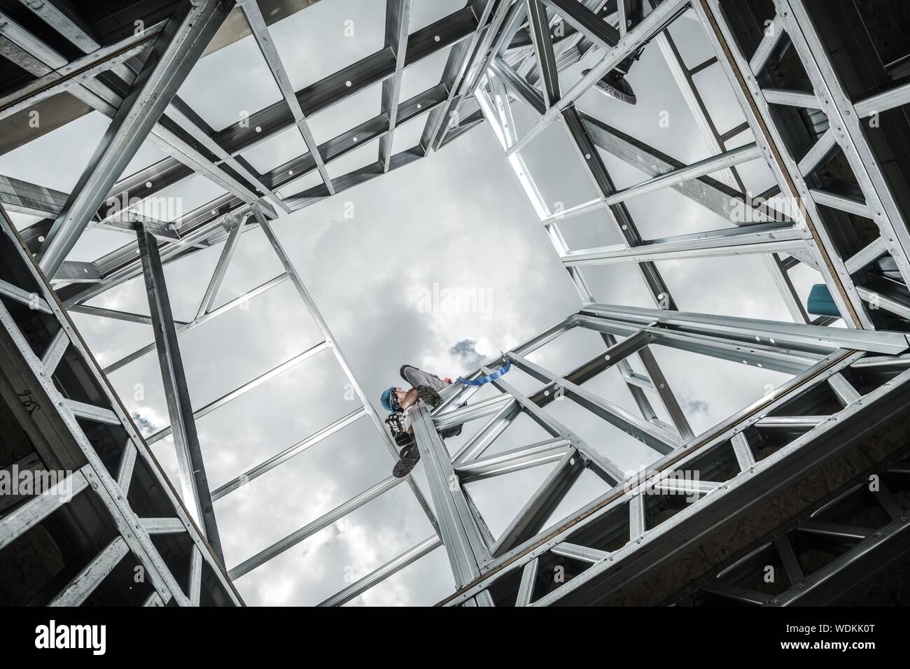 Steel Building Construction and Caucasian Contractor Worker at the Top ...