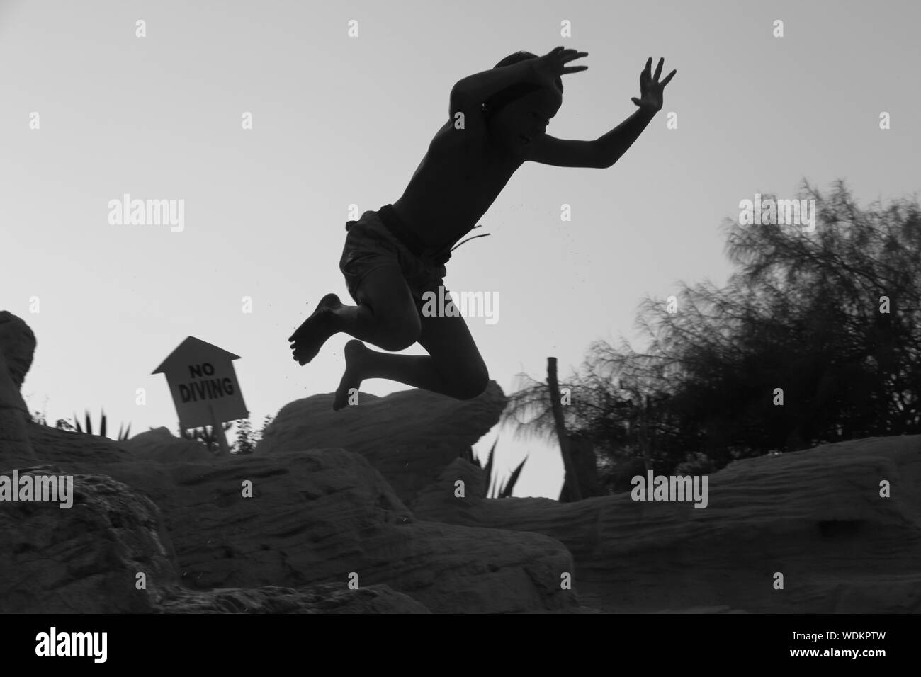 Boy jumping into pond hi-res stock photography and images - Alamy