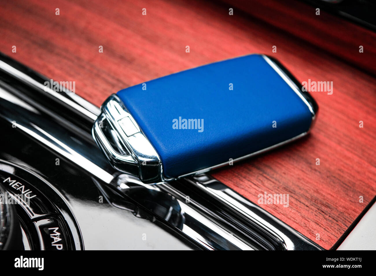 Closeup inside vehicle of wireless blue leather key ignition on natural ...