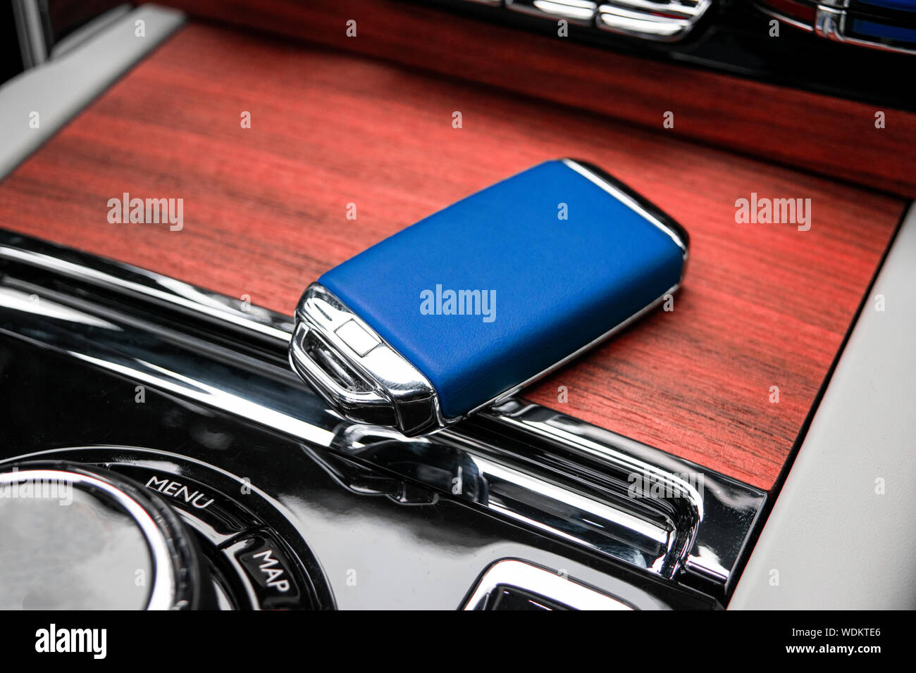 Closeup inside vehicle of wireless blue leather key ignition on natural ...