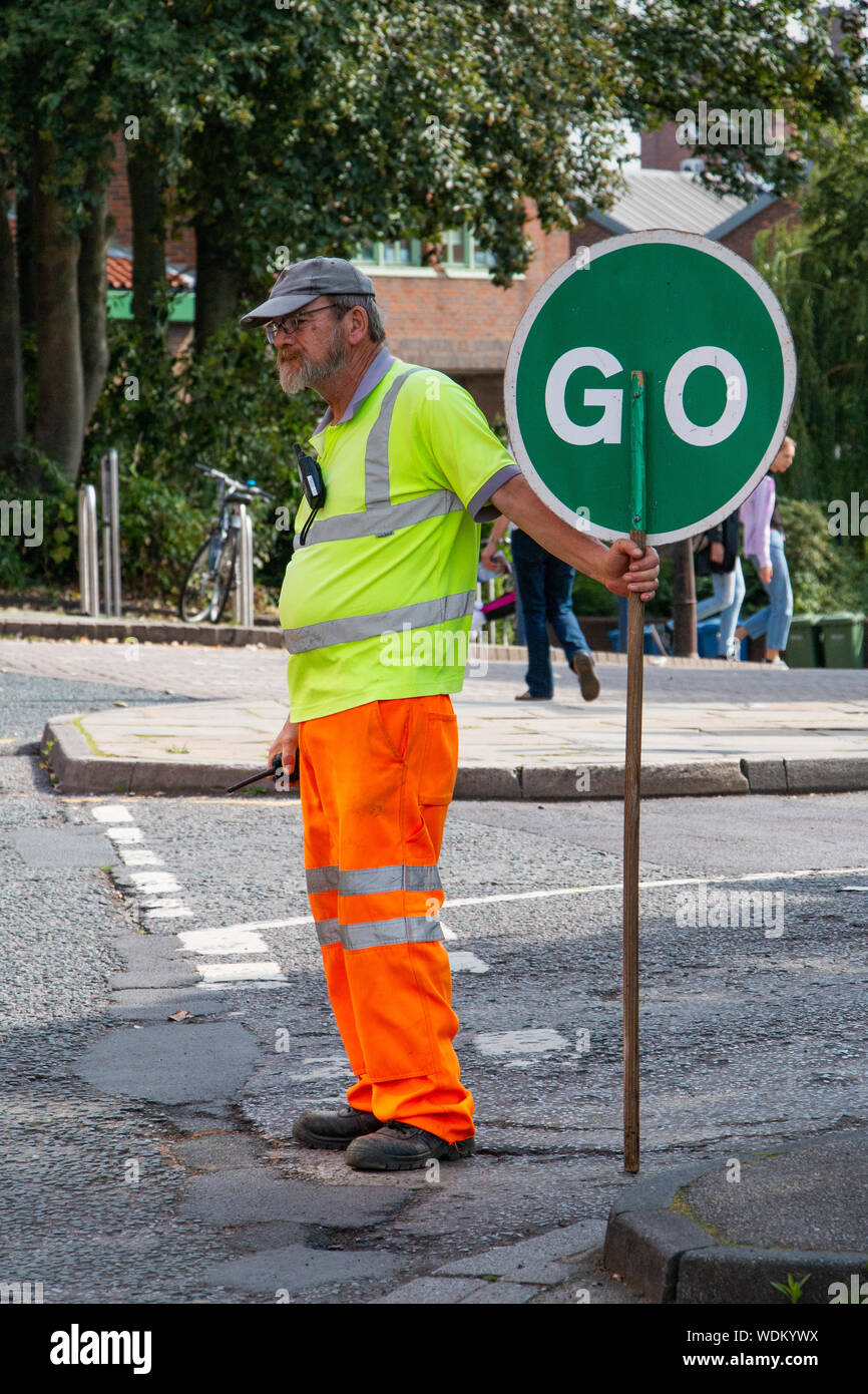A steward holding a Stop Go sign and controlling traffic during the ...