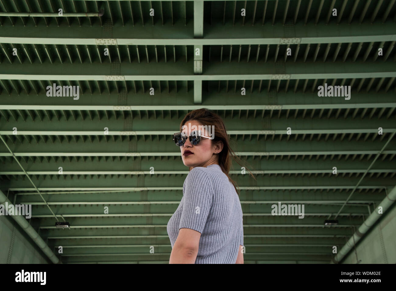 Portrait Of Young Woman Looking Over Shoulder Stock Photo - Alamy