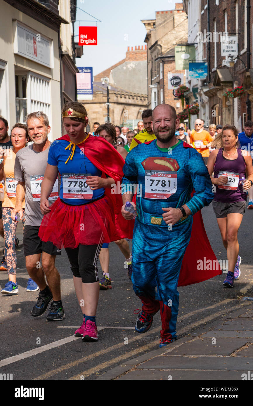 Costume runners in the York 10k run down Castlegate Stock Photo - Alamy