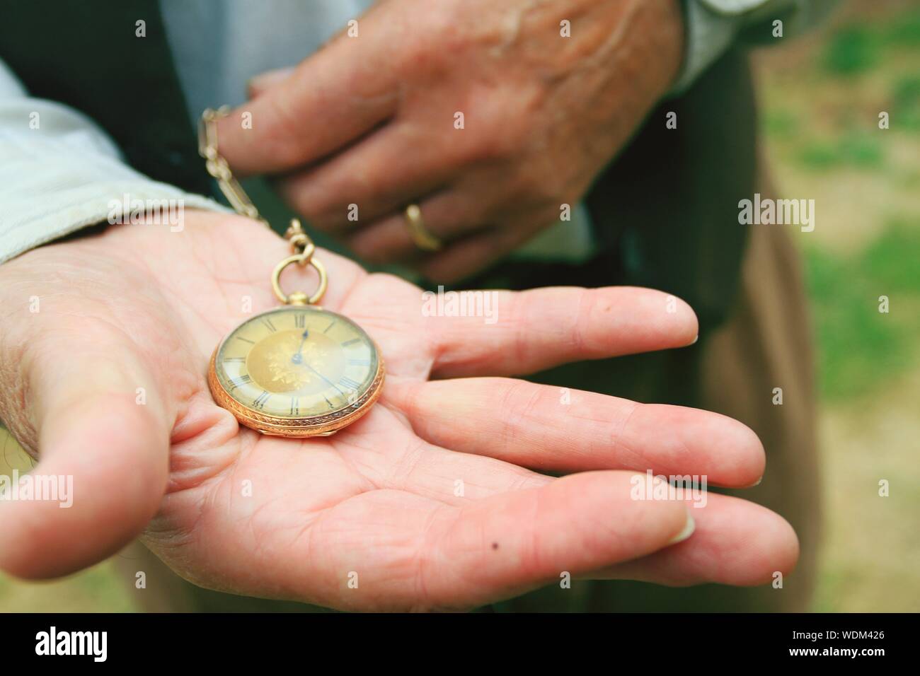 Hand holding watch hi-res stock photography and images - Alamy