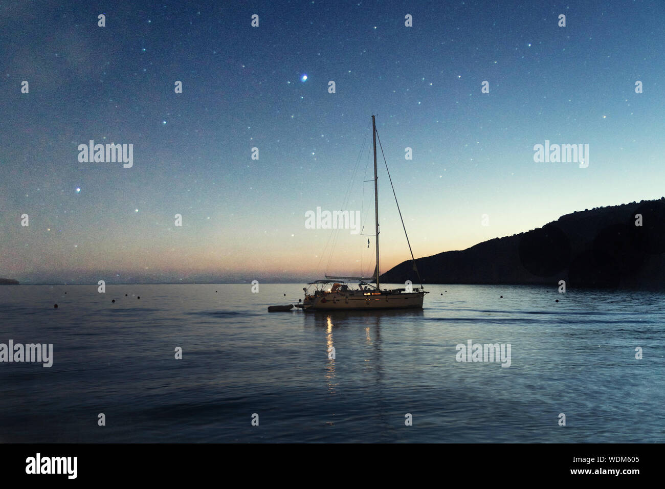 Ship sailing into the horizon Stock Photo - Alamy