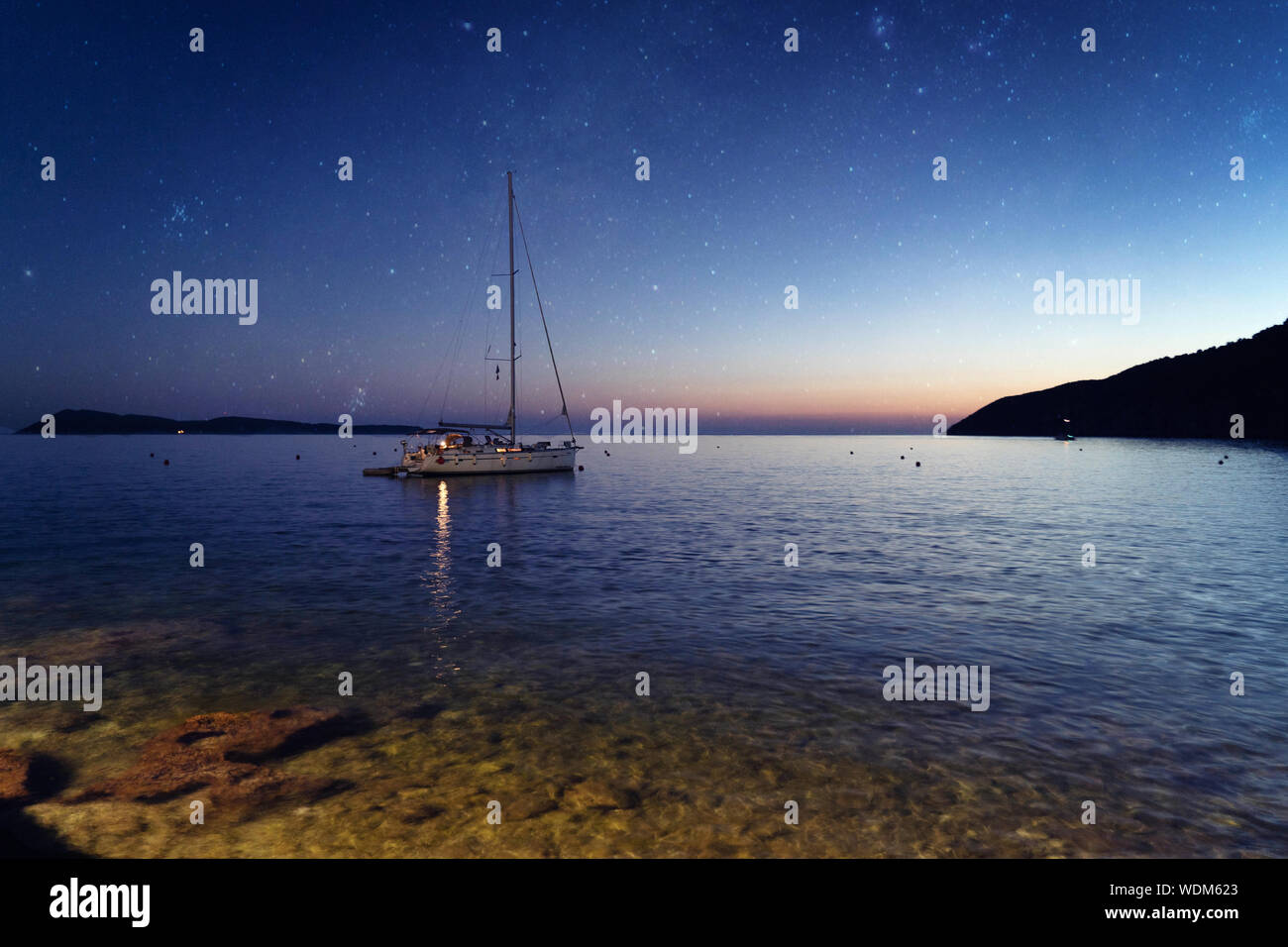 Ship sailing into the horizon Stock Photo - Alamy