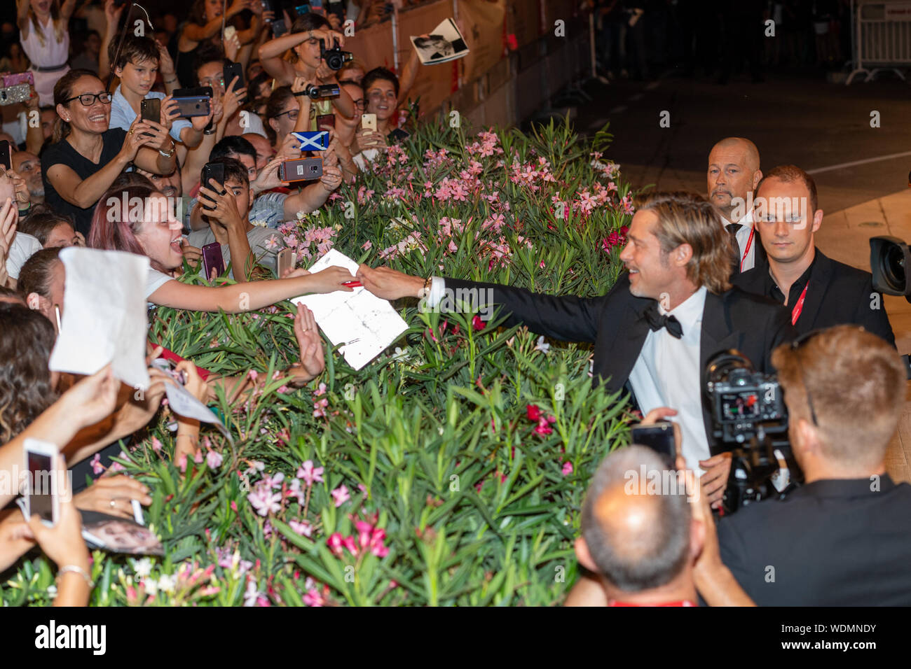 VENICE, Italy. 29th Aug, 2019. Brad Pitt signs an autograph to a fan at ...
