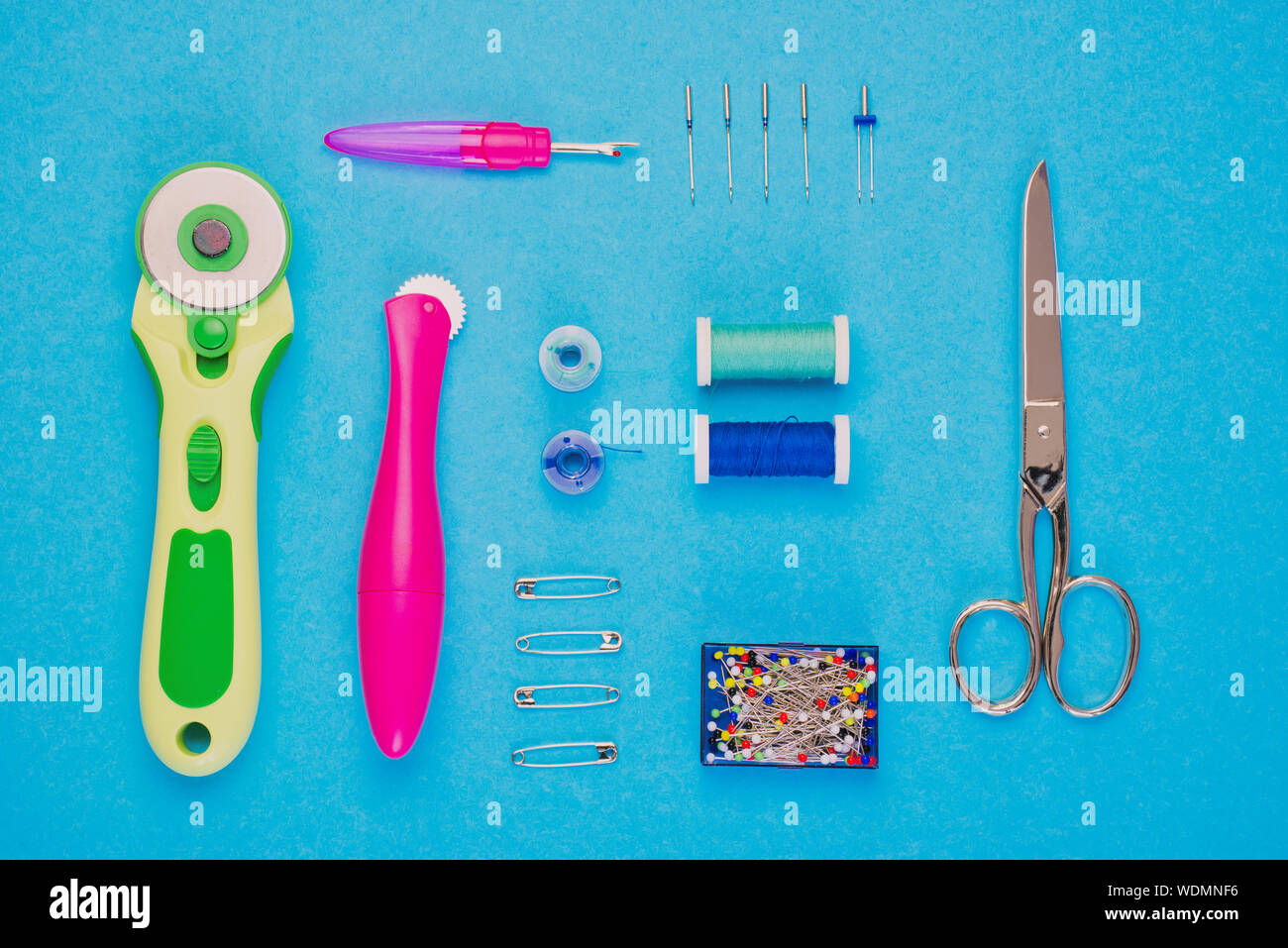 important sewing equipment photographed from above against blue ...