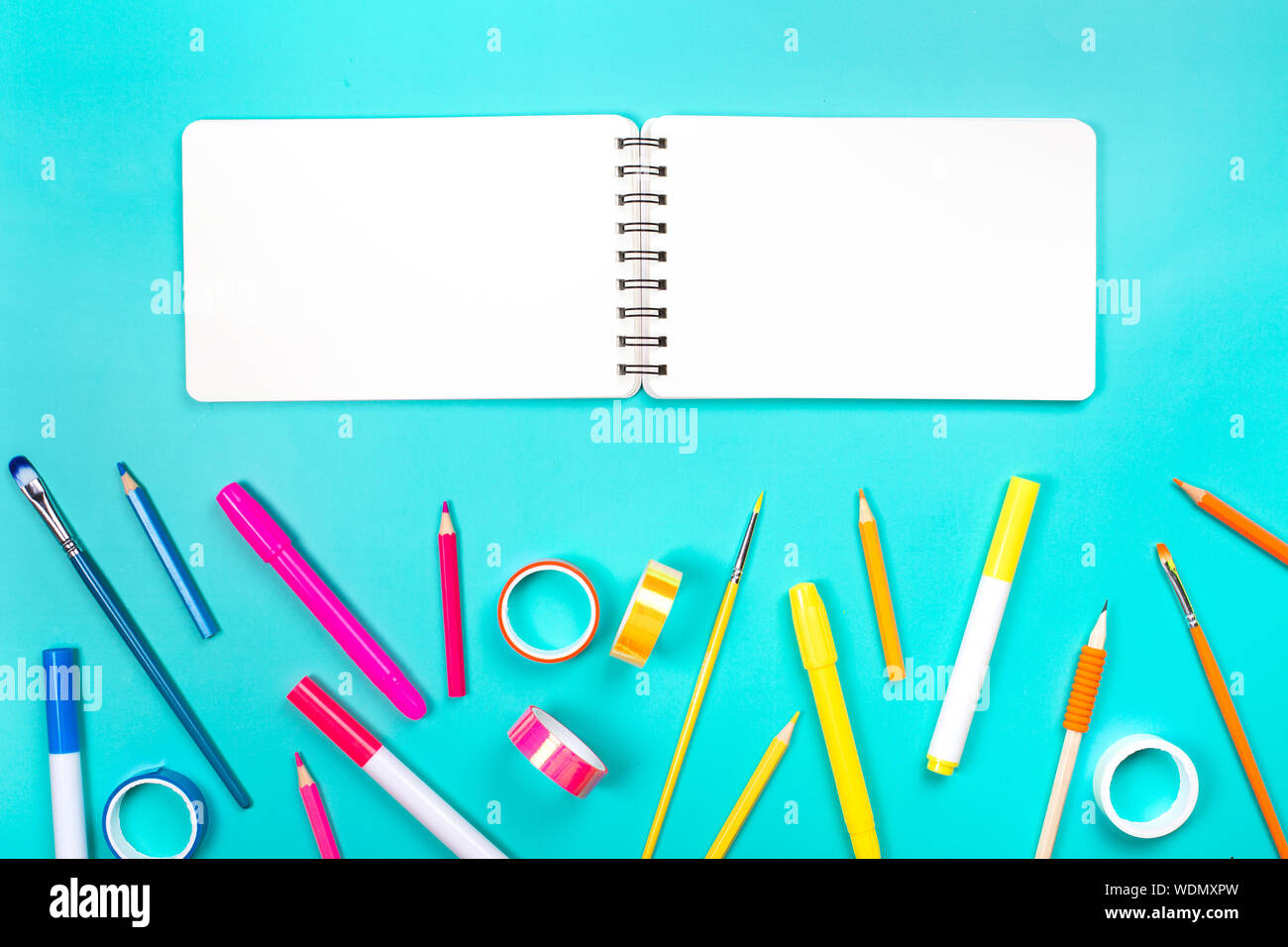 School items as a frame on blue background. Trendy colors, flat lay ...