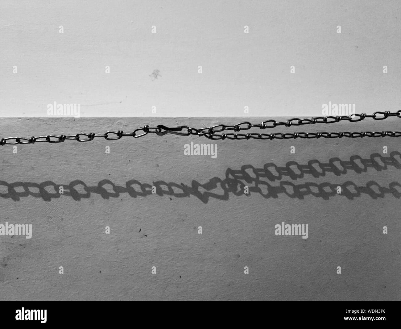 Chain With Shadow On Wall Stock Photo - Alamy