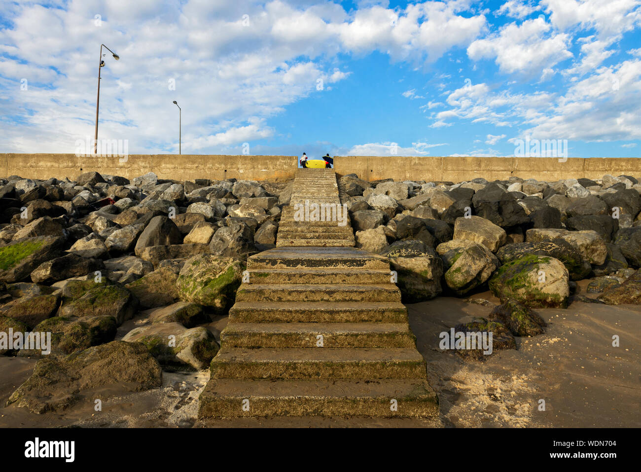 Lahinch Beach boulders and concrete stairs at low tide, County Clare ...