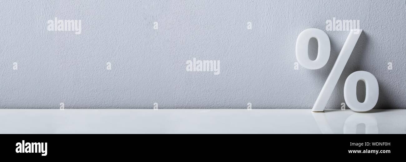 Close-up Of Percent Symbol In Front Of White Wall Stock Photo - Alamy