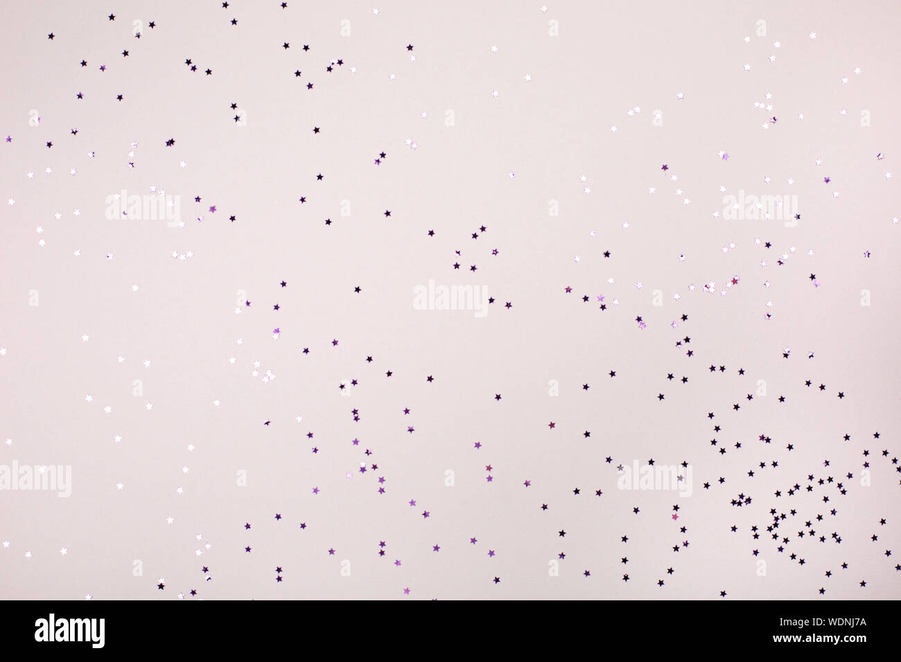 Little purple stars on grey background. Festive concept Stock Photo - Alamy