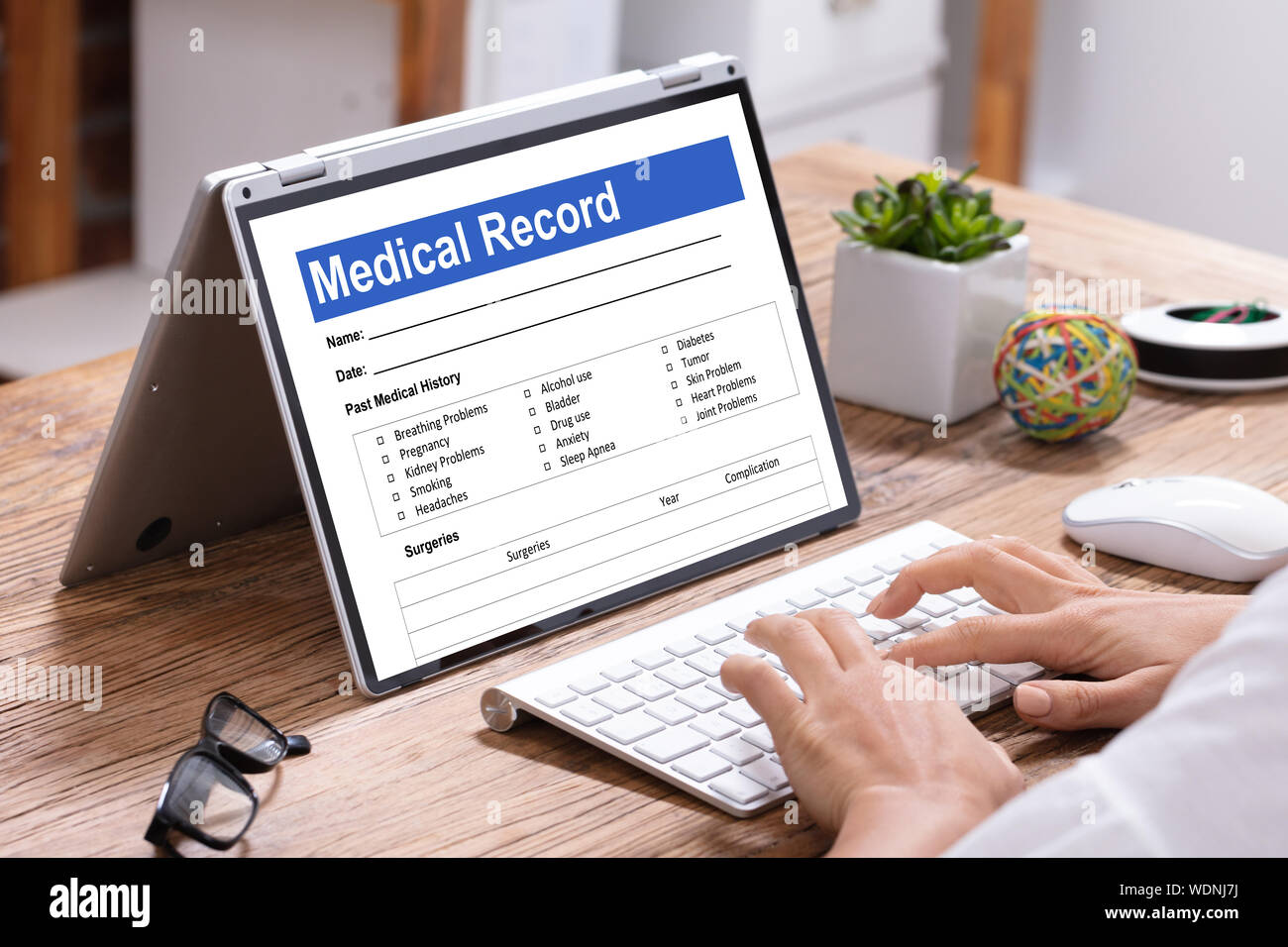 Female Doctor Filling Patient Information Form On Digital Laptop Over ...
