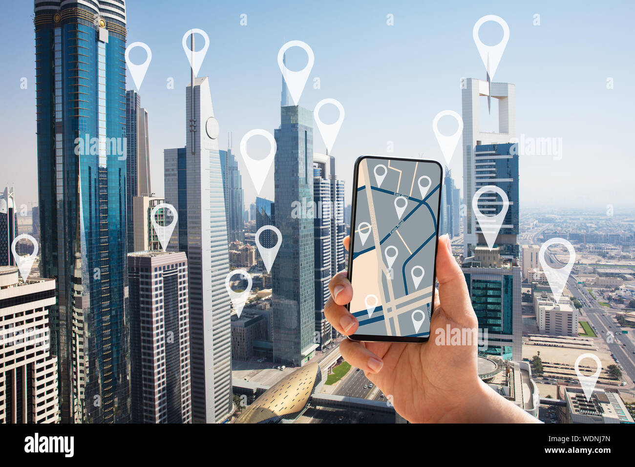 Tourist Using GPS Map Navigation Application On Smartphone Screen In Dubai City With Location ...