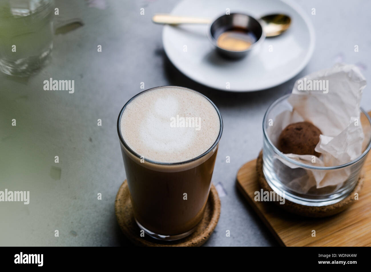 Masala chai latte with honey and vegan candy from above on light gray ...