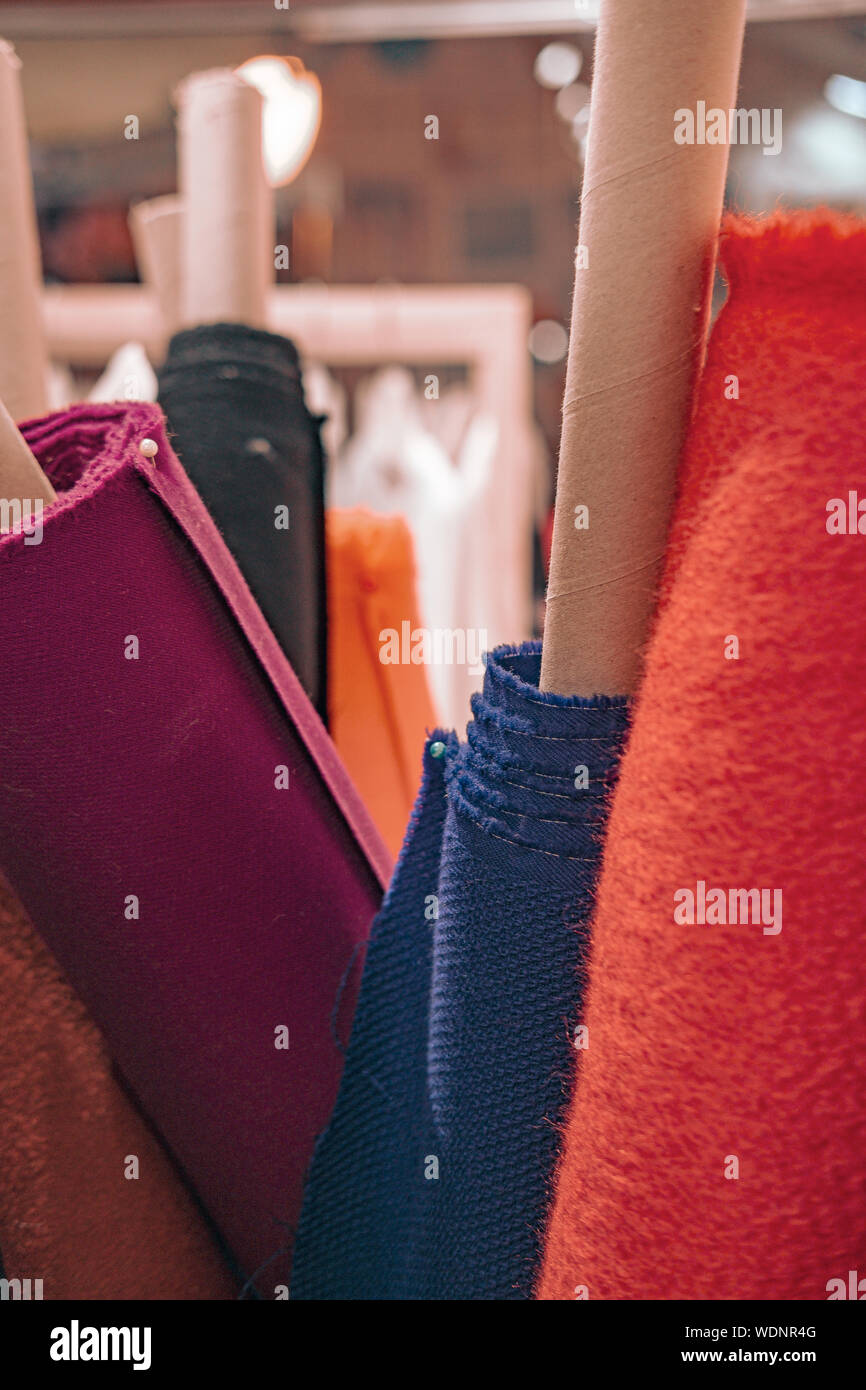 Rolls of natural high fashion fabrics and textiles. Sewing industry ...