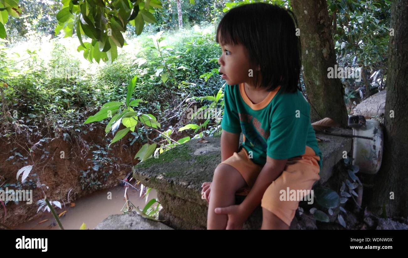 Boy sitting on stone hi-res stock photography and images - Alamy