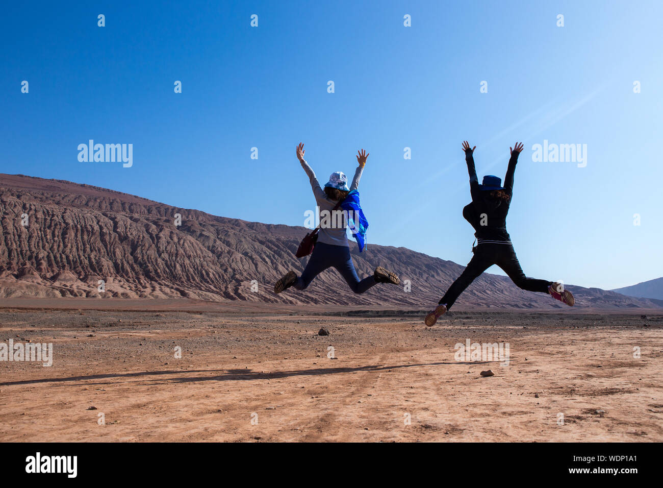 Two woman jumping hi-res stock photography and images - Alamy