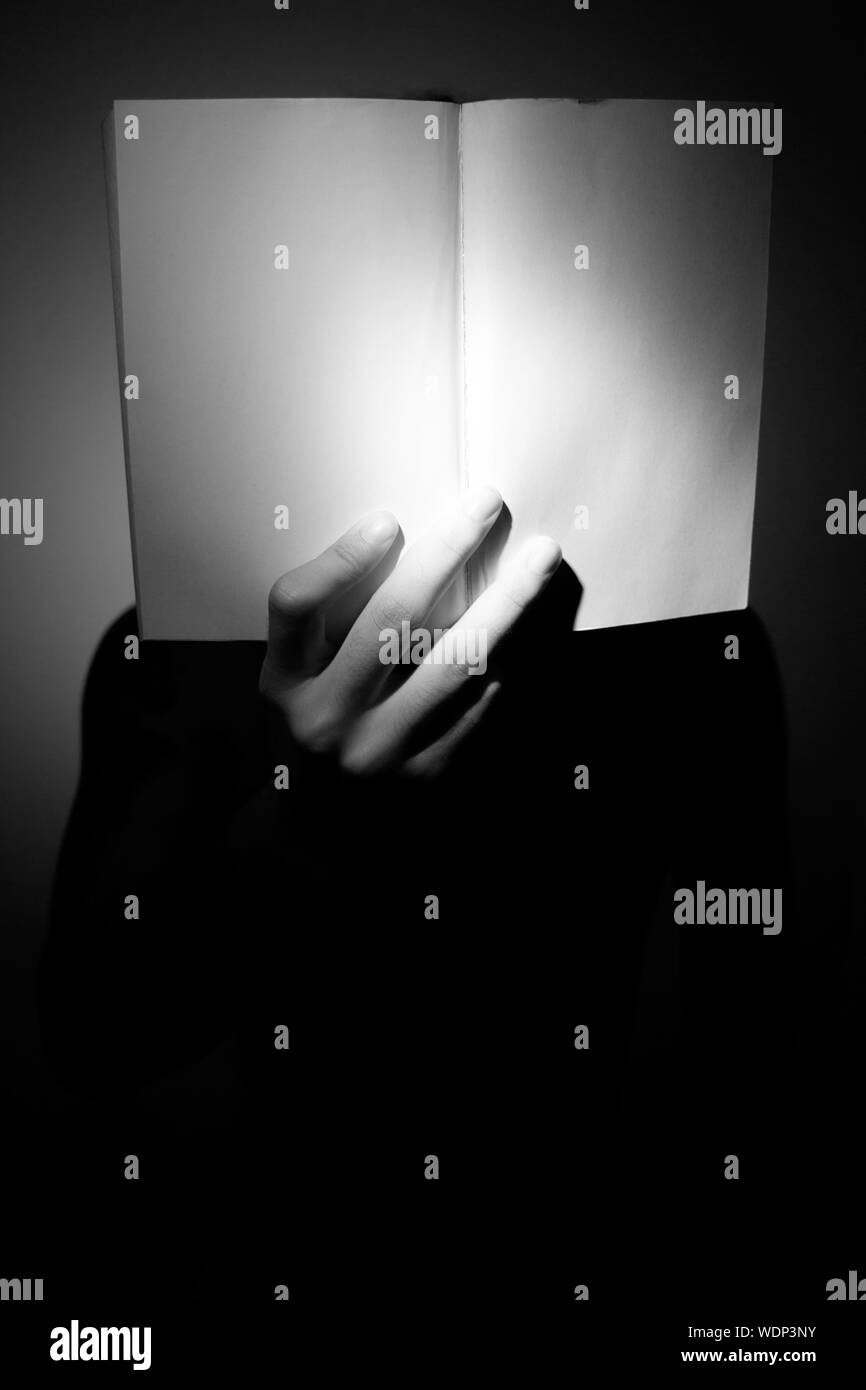 Human hand holding open book Black and White Stock Photos & Images - Alamy