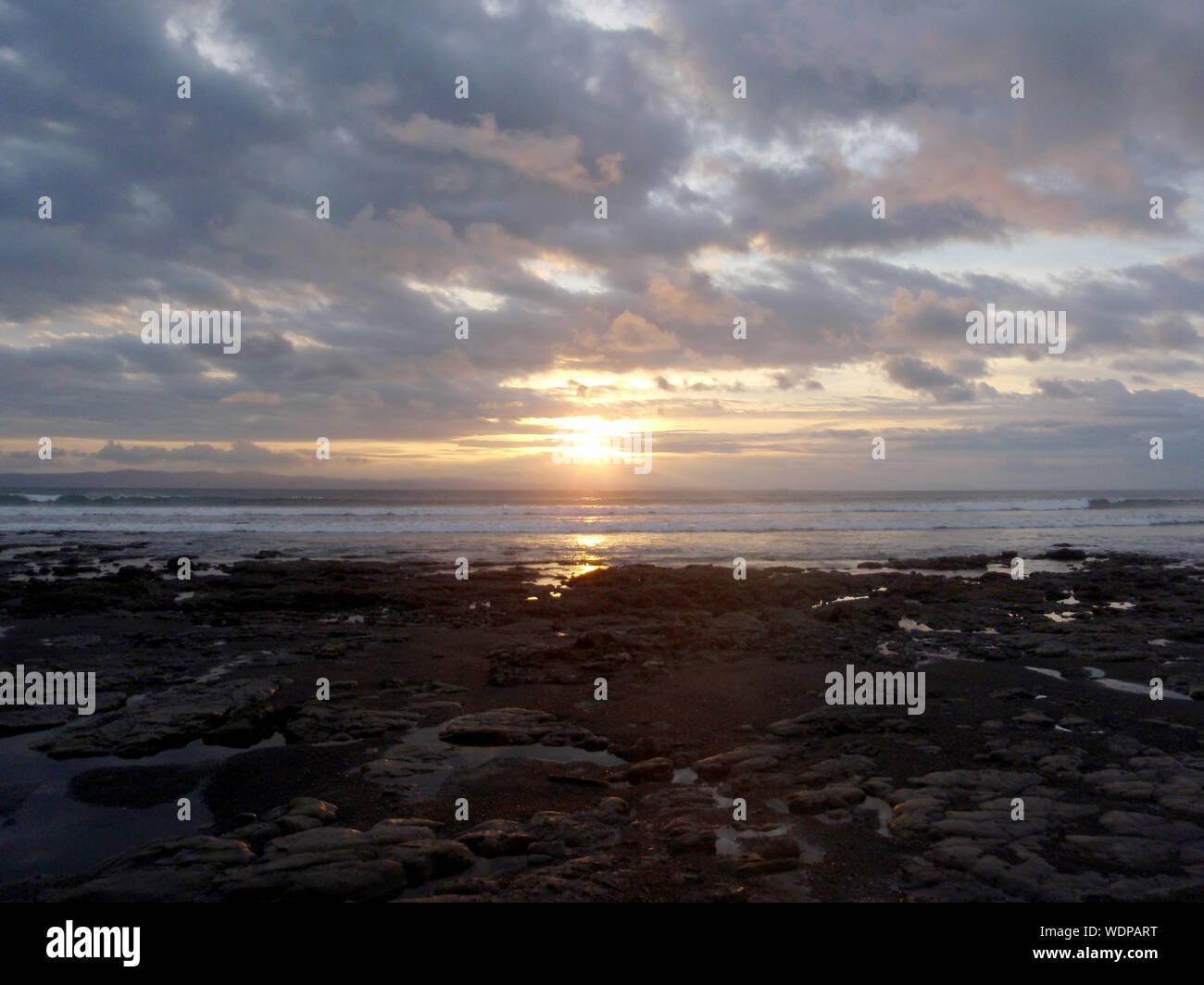 Sunset over rocky beach in punta banco hi-res stock photography and ...