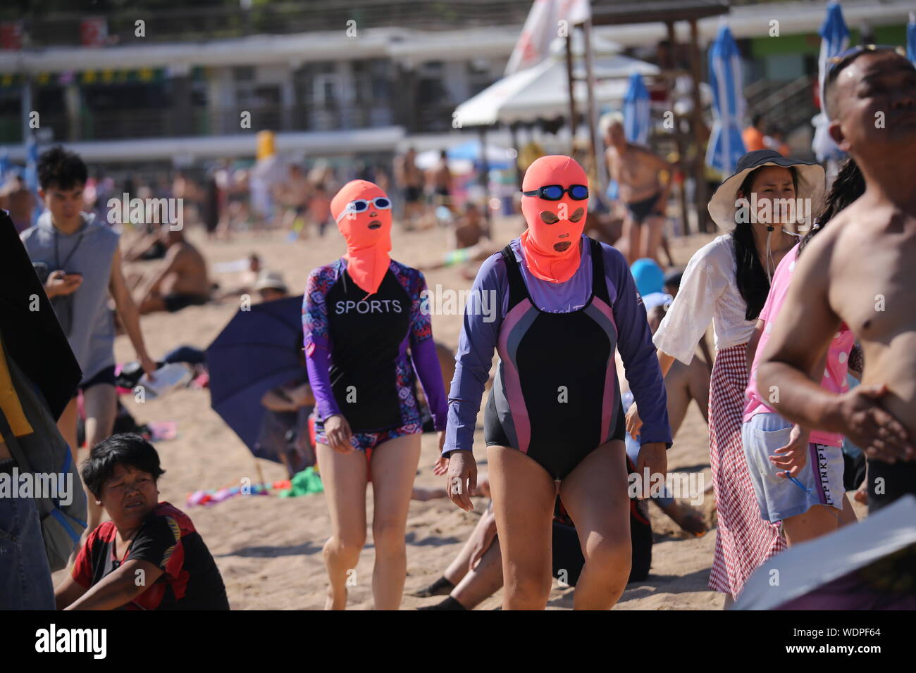 Shandong, China. 29th Aug, 2019. A facekini woman taking a bath at ...
