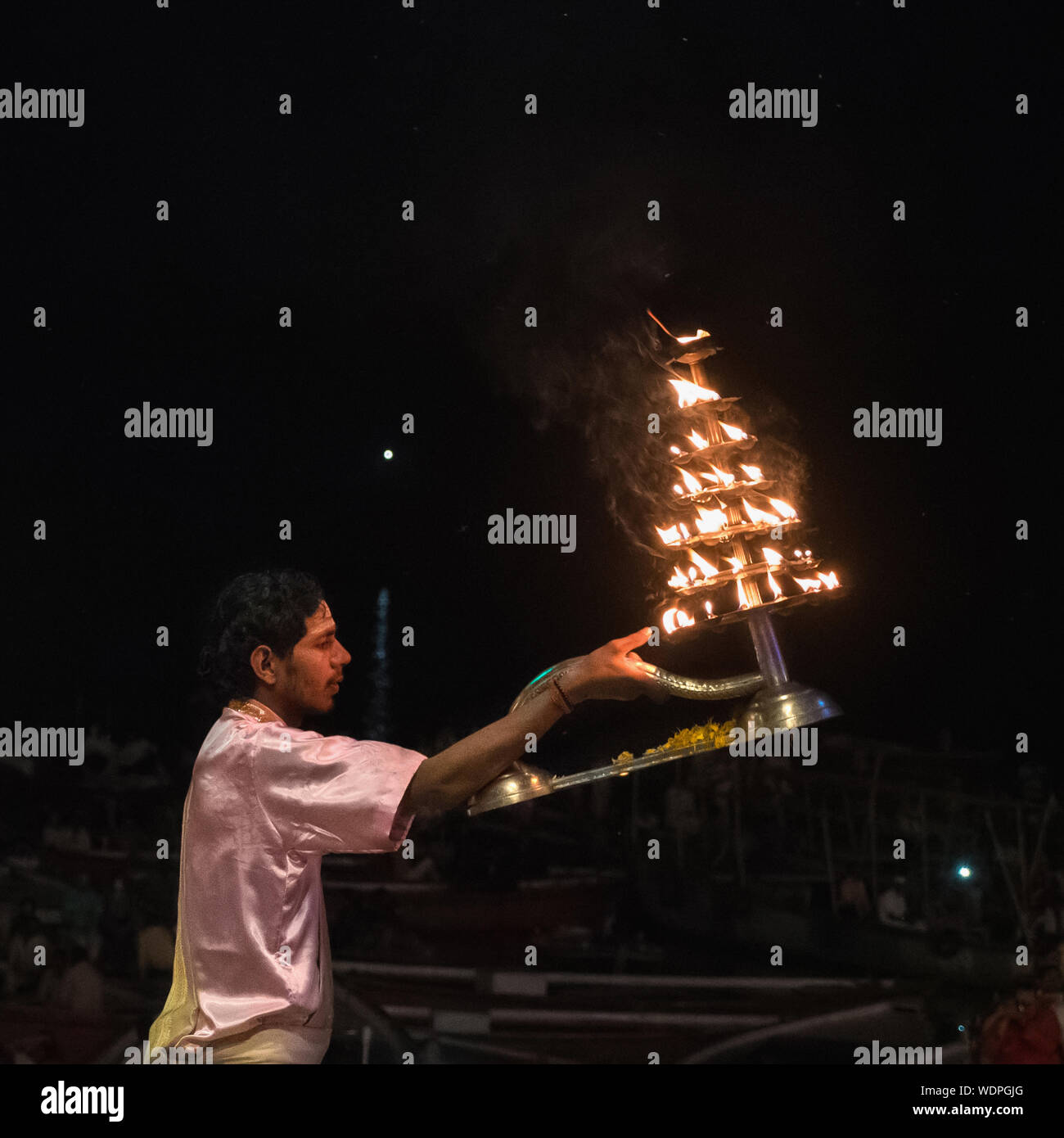 Indian Hindu priest holding candles during the Ganga Aati ritual at the ...