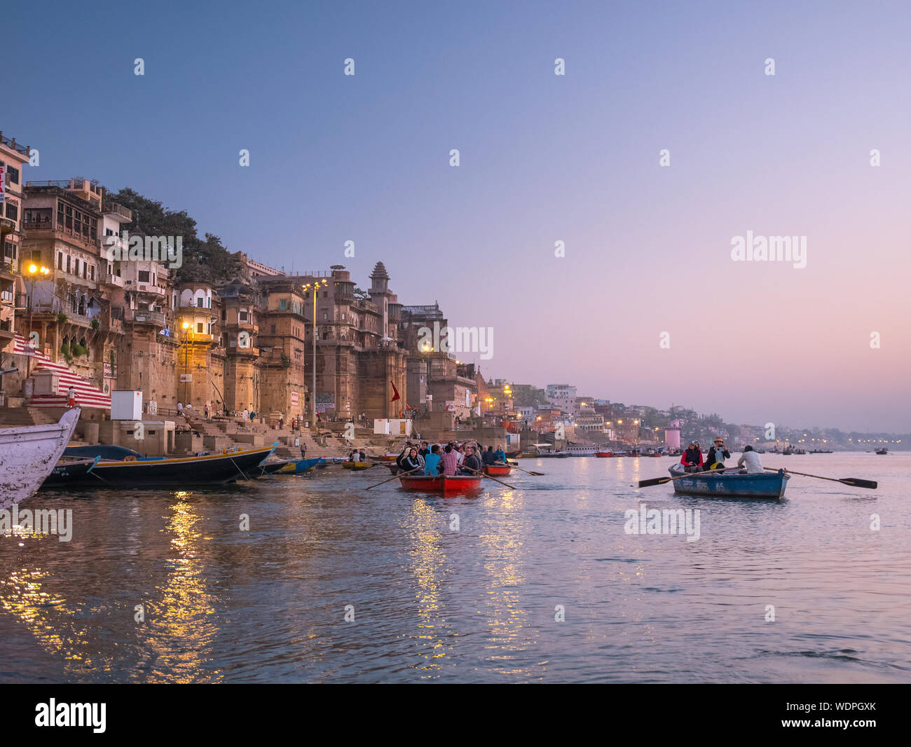 View of Varanasi ghats and local boats from across the Ganges River in ...