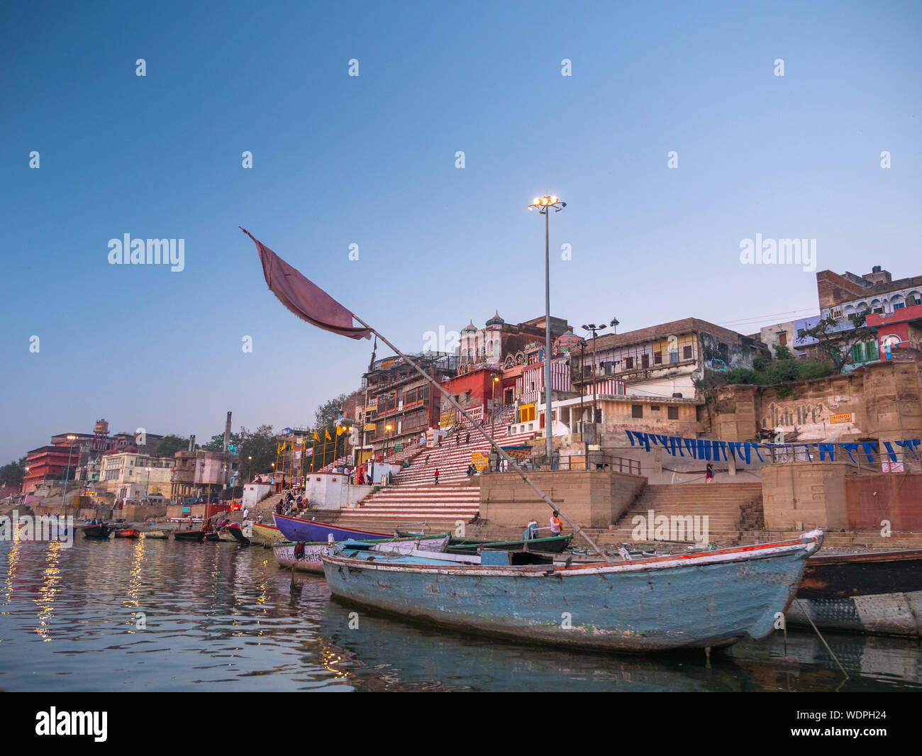 View of Varanasi ghats and local boats from across the Ganges River in ...