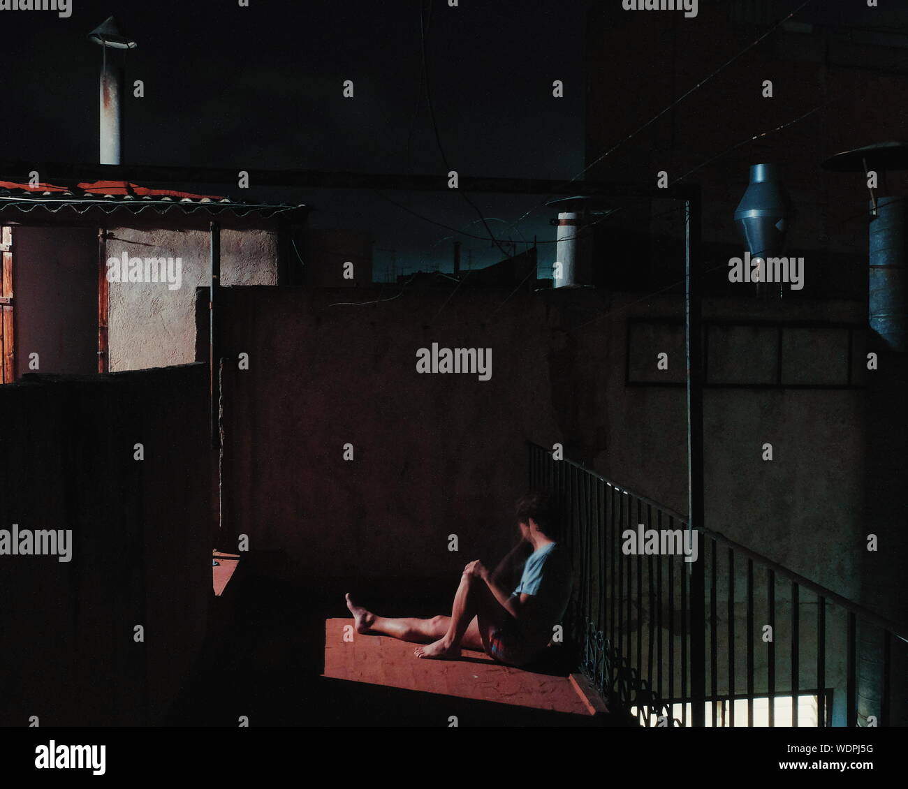 Man sitting on rooftop hi-res stock photography and images - Alamy