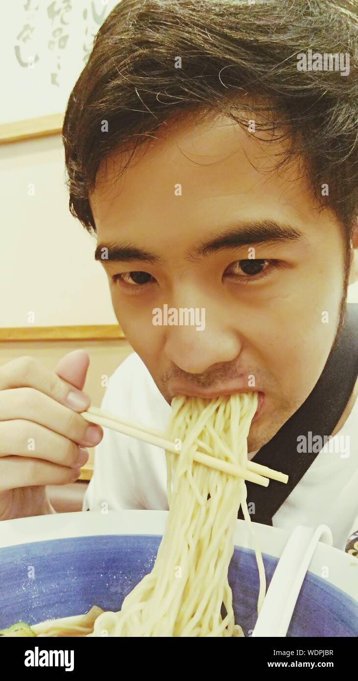 Asian man eating noodles hi-res stock photography and images - Alamy