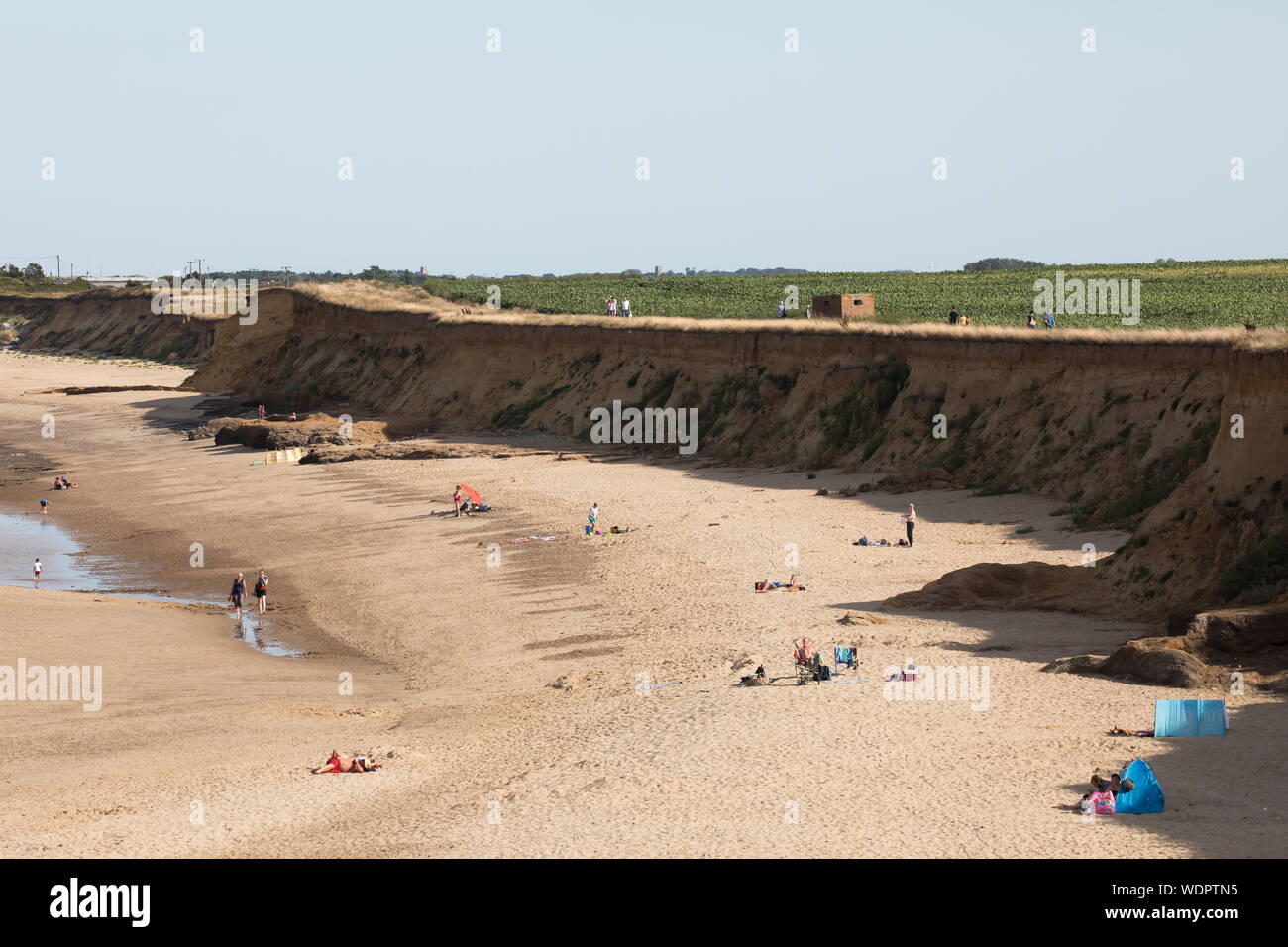 People enjoying the sunshine on Happisburgh Beach in Norfolk on a sunny ...