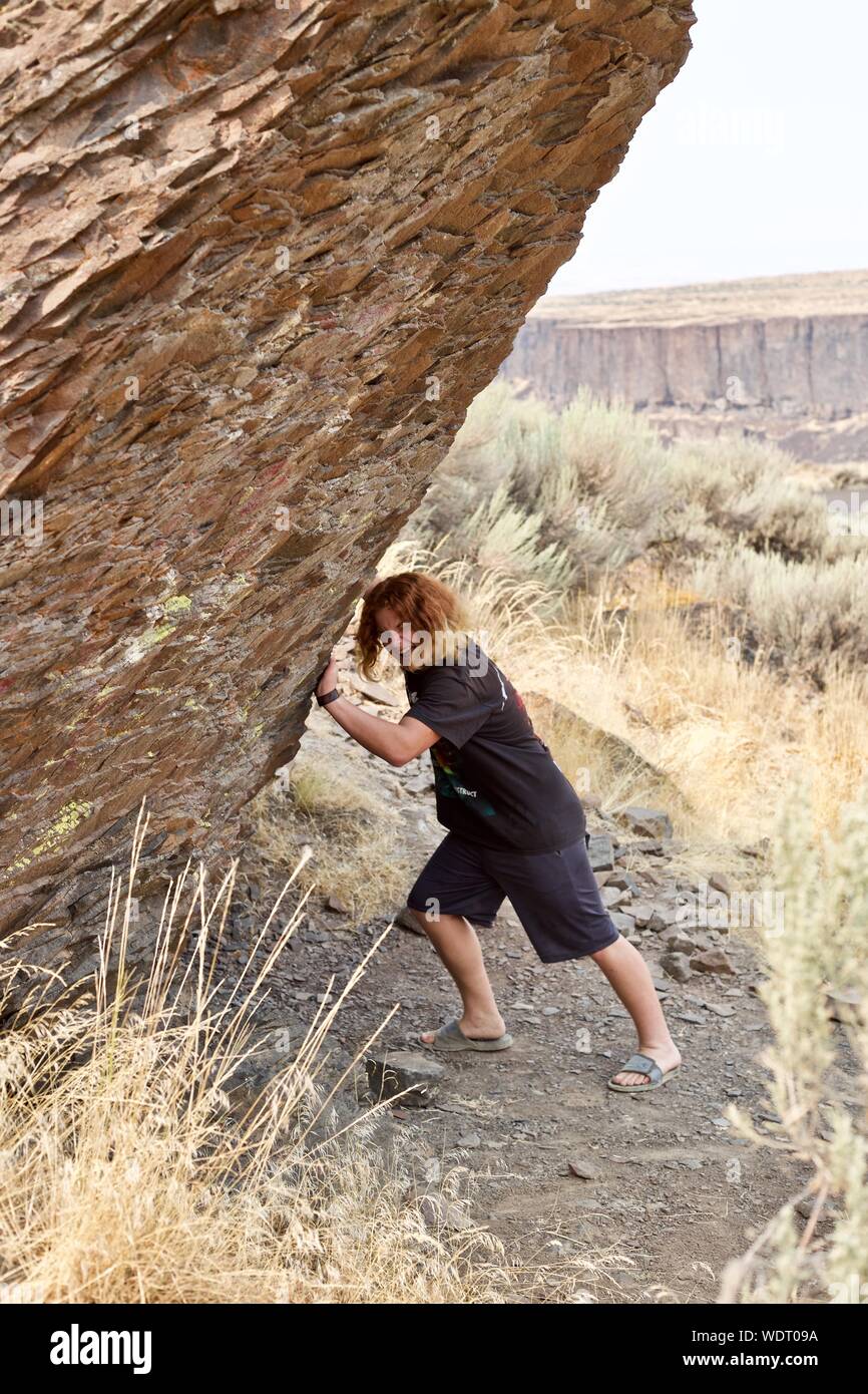 Pushing the rock hi-res stock photography and images - Alamy