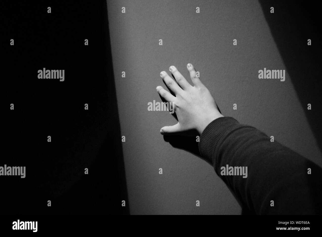 Hand touching wall Black and White Stock Photos & Images - Alamy