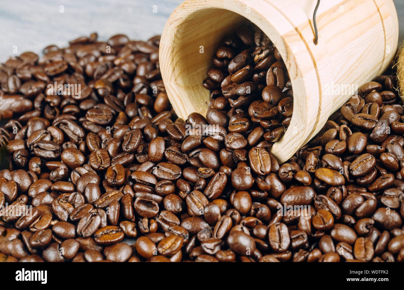 Coffee beans in small wooden bucket with roasted coffee beans ...