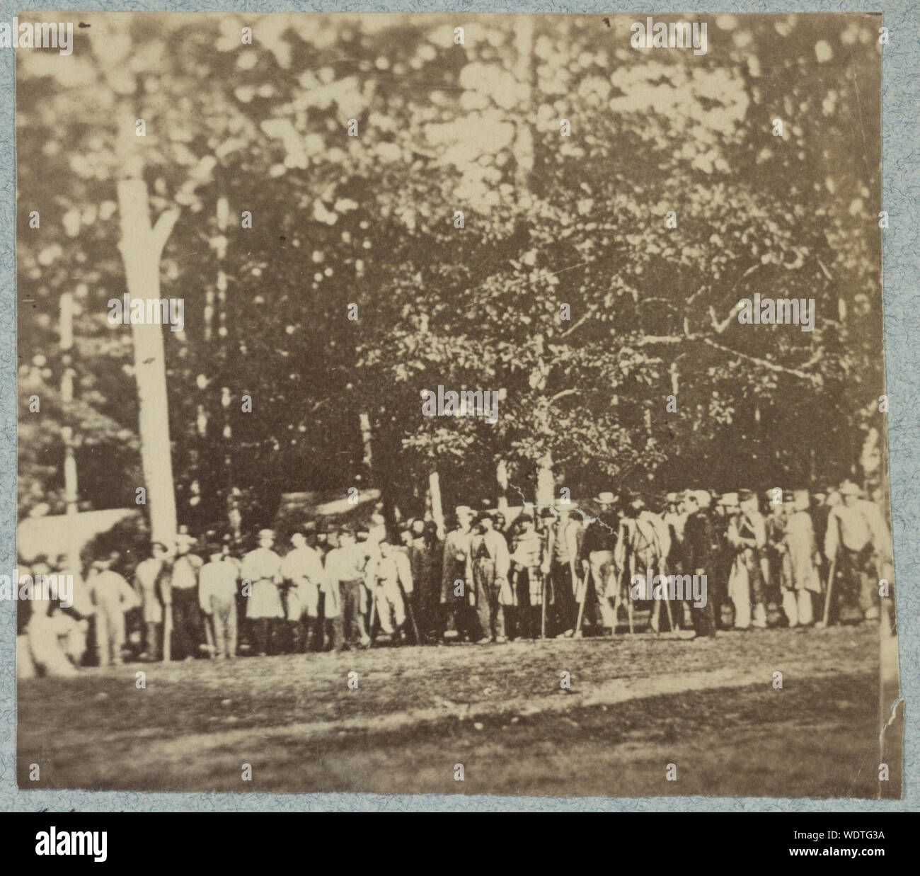 Group of soldiers, some in uniform and some with crutches, pose in ...