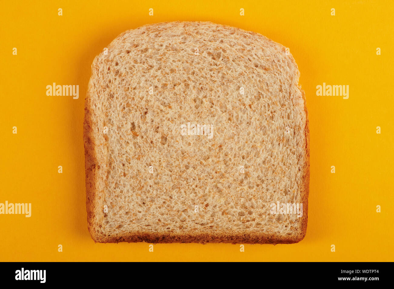 One white bread slice above top view on yellow background Stock Photo ...
