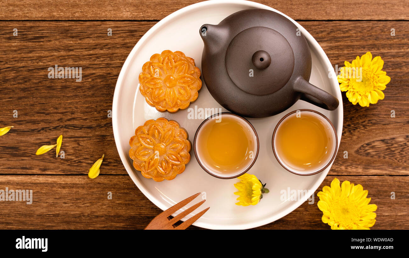Moon cakes with tea on dark wooden table, holiday concept of Mid-Autumn ...