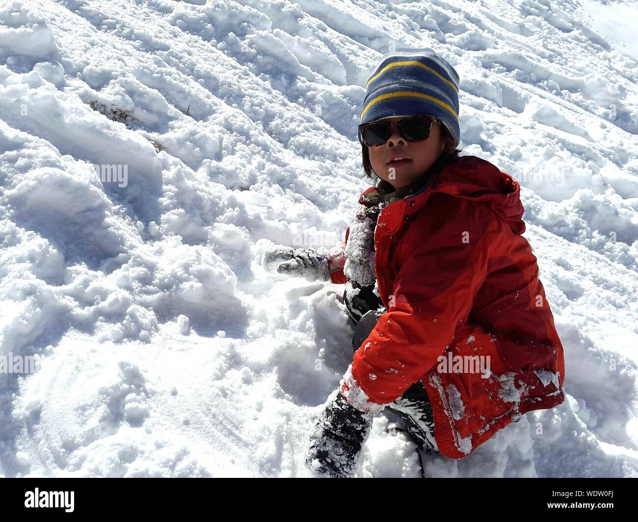Boy in red snow jacket hi-res stock photography and images - Alamy